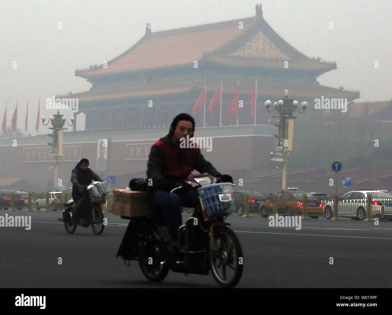 Chinese commute on bike under a thick smog near Tiananmen Square in ...