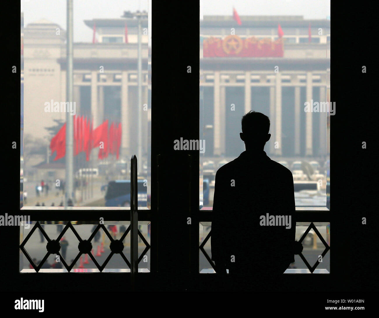 A Chinese security guard stands watch as China's top leaders, including ...