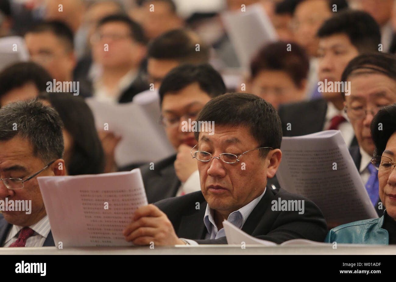 Chinese members of the National People's Congress (NPC) follow Chinese ...