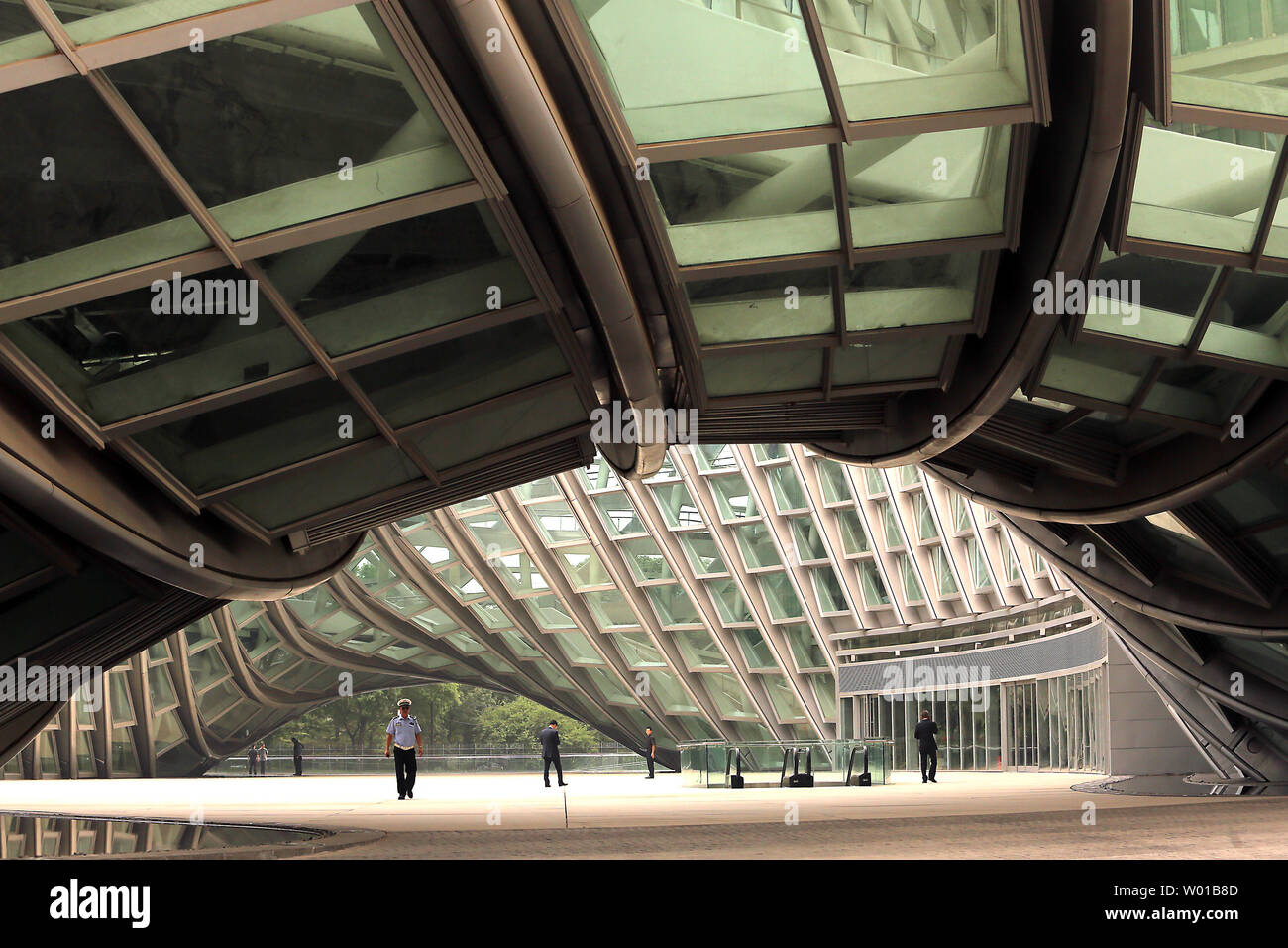 A Chinese police officer patrols a newly constructed office building in ...