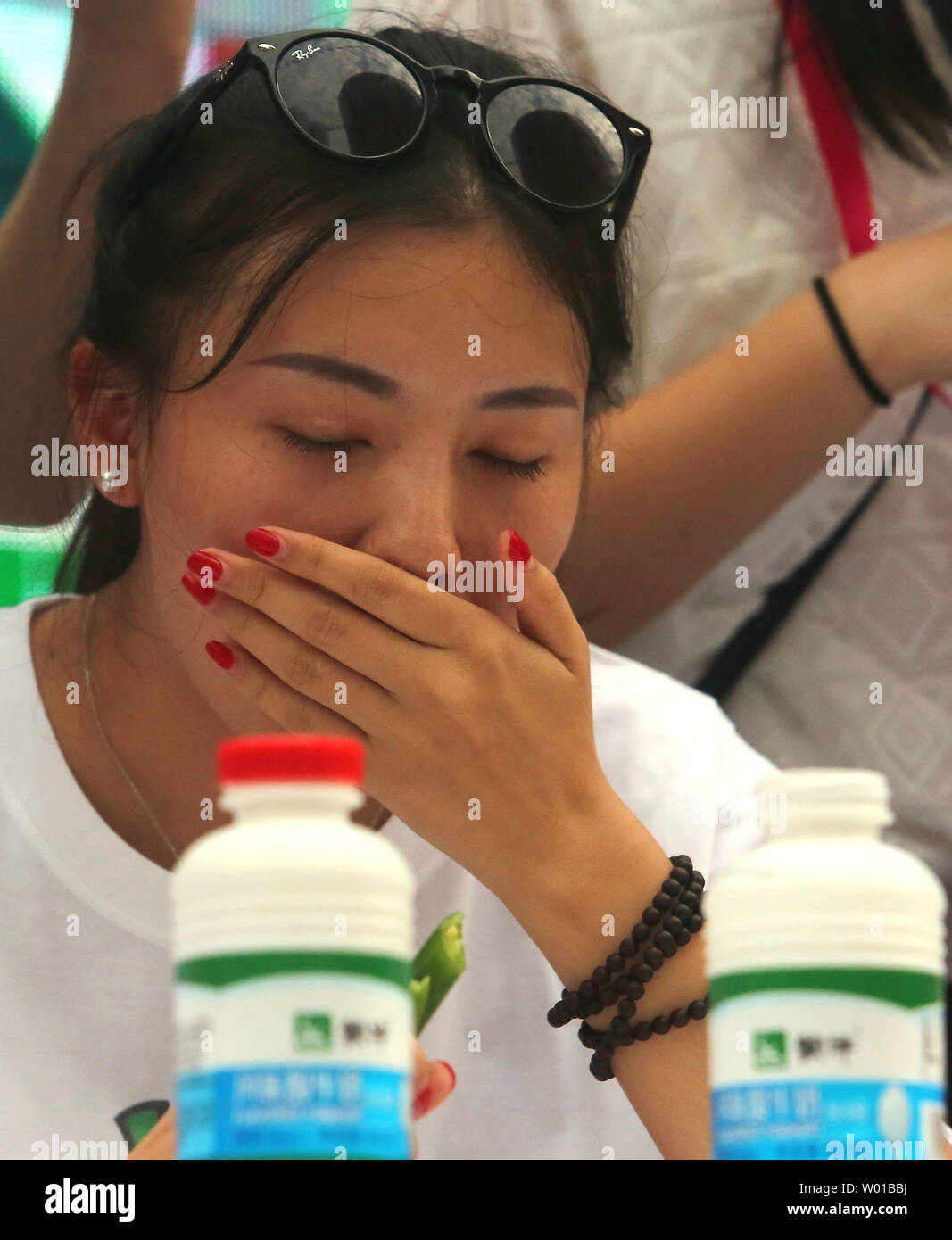 A Chinese woman competes in a chili eating contest at a food fair in ...