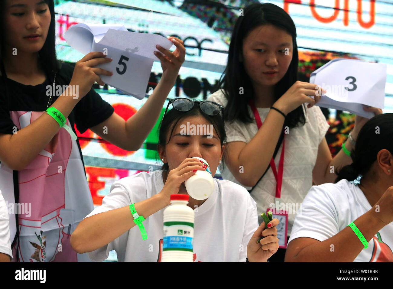 A Chinese woman competes in a chili eating contest at a food fair in ...