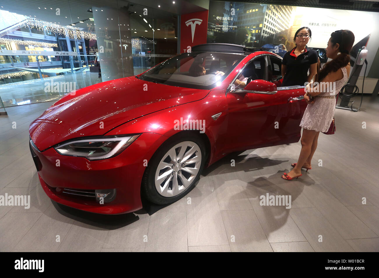 Chinese check out the latest Tesla cars on display in its flagship ...