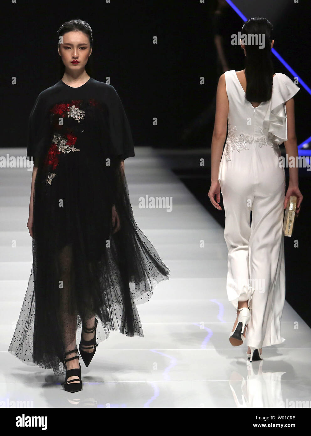 Chinese models wear dresses made by Chinese fashion designer Tom Dong ...
