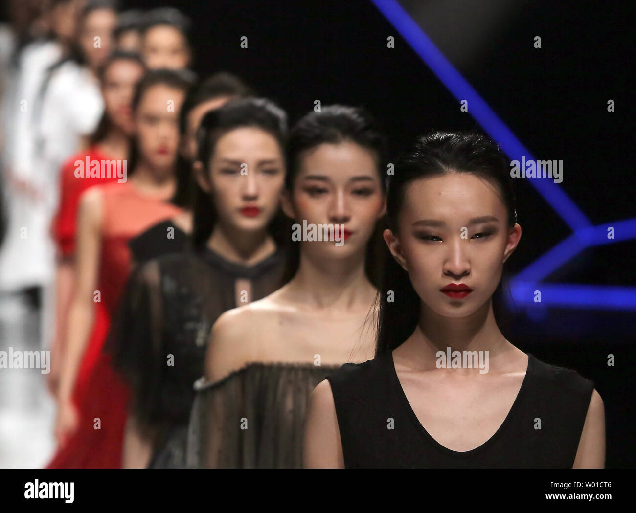 Chinese models wear dresses made by Chinese fashion designer Tom Dong ...