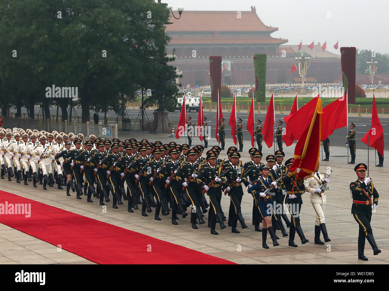 Chinese soldiers march as they perform honor guard duties for a ...