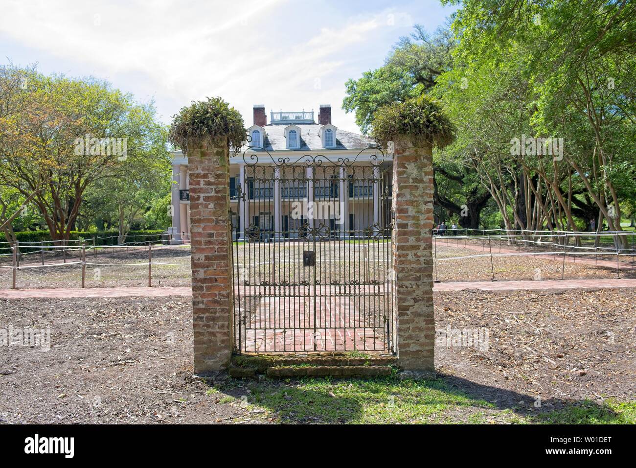 Entrance gate between two brick columns outside the historic Oak Alley ...