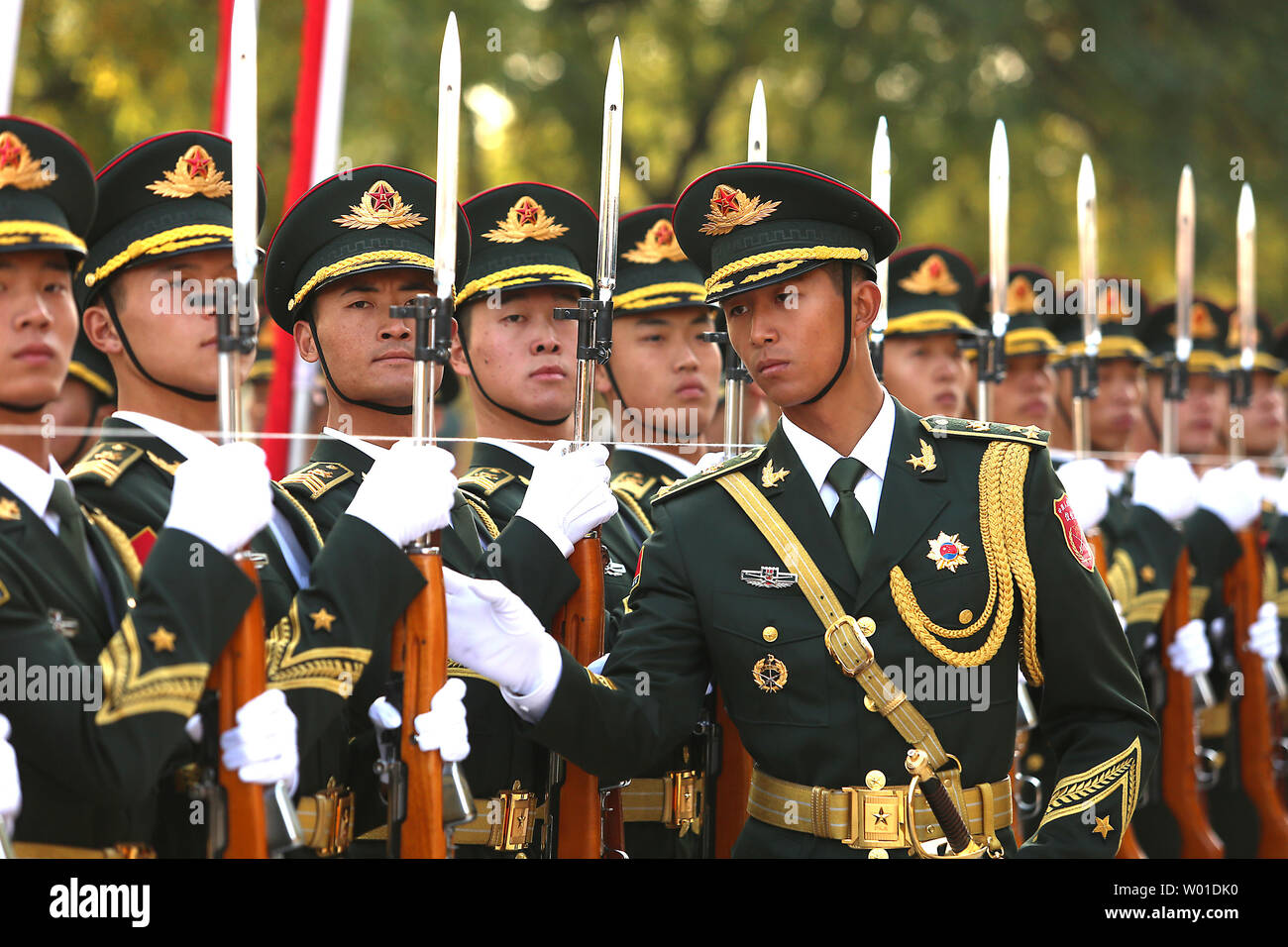 Chinese soldiers prepare to perform military honor guard duties for a welcoming ceremony at the ...
