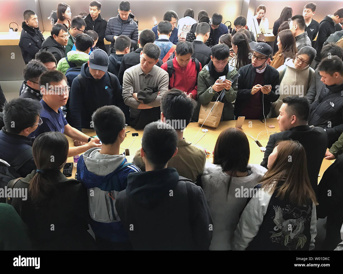 An Apple employee demonstrates the features of the newly released ...