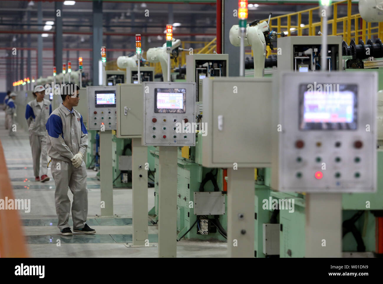 Chinese technicians monitor the precision, robotic welding of aviation ...