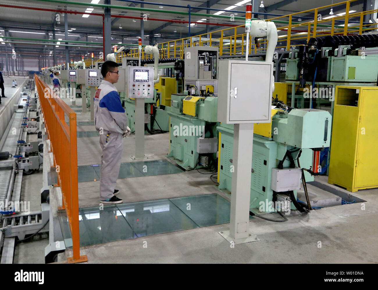 Chinese technicians monitor the precision, robotic welding of aviation ...