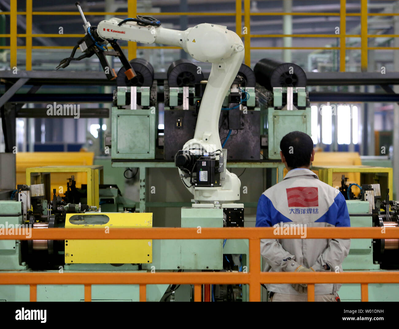 Chinese technicians monitor the precision, robotic welding of aviation ...