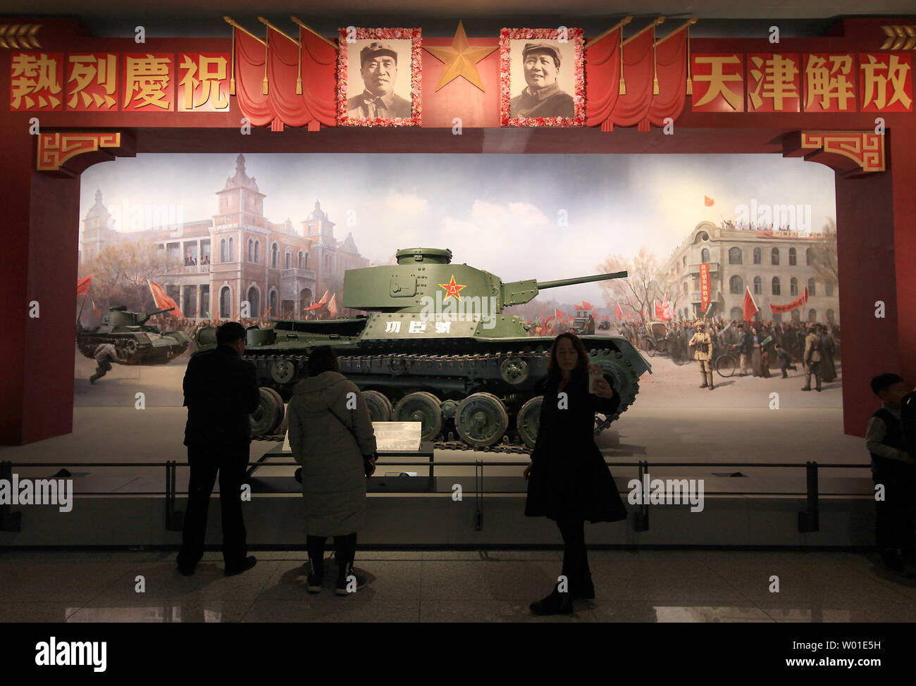 Chinese visitors look at tanks used in war on display at the Military ...