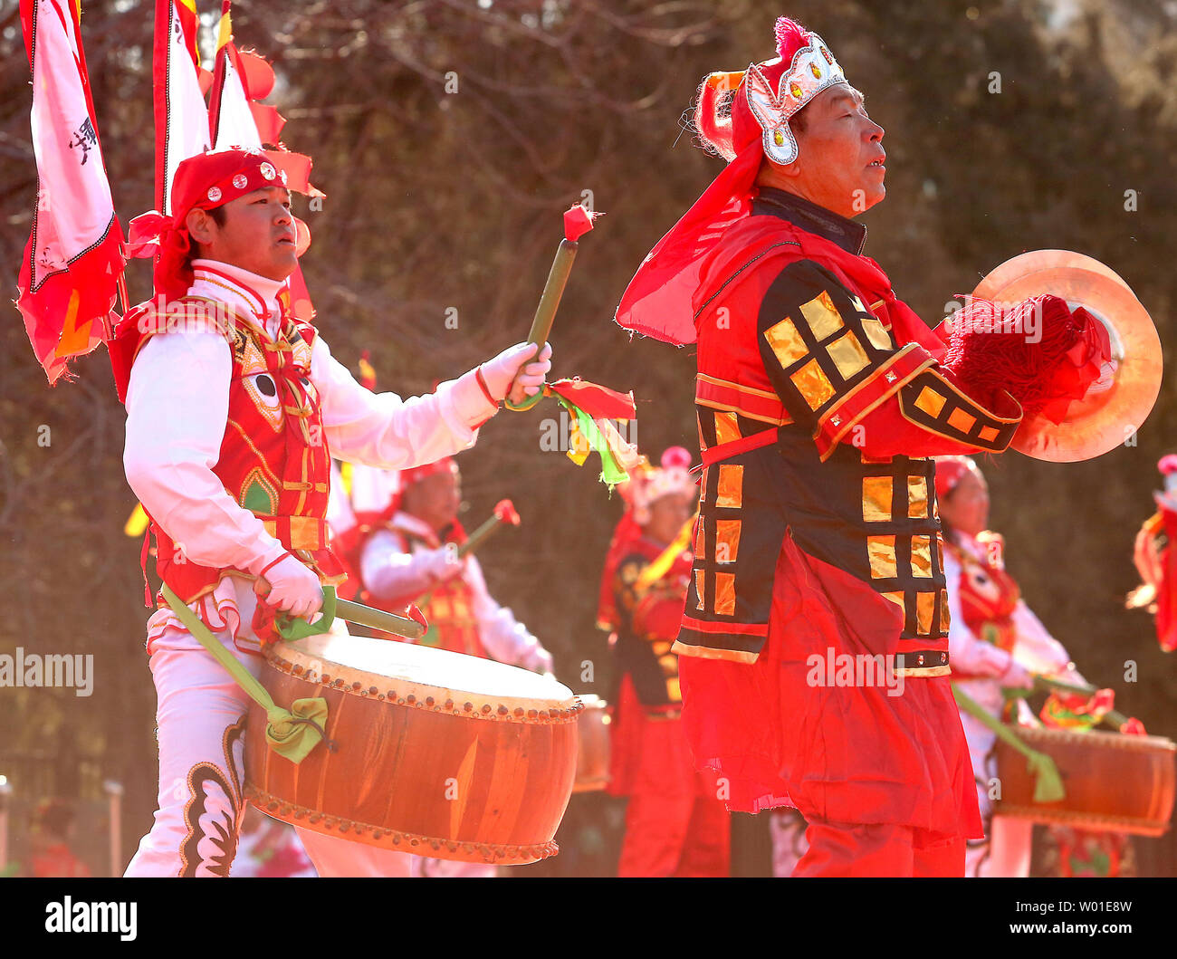 Chinese actors perform on an outdoor stage for a large crowd at a ...