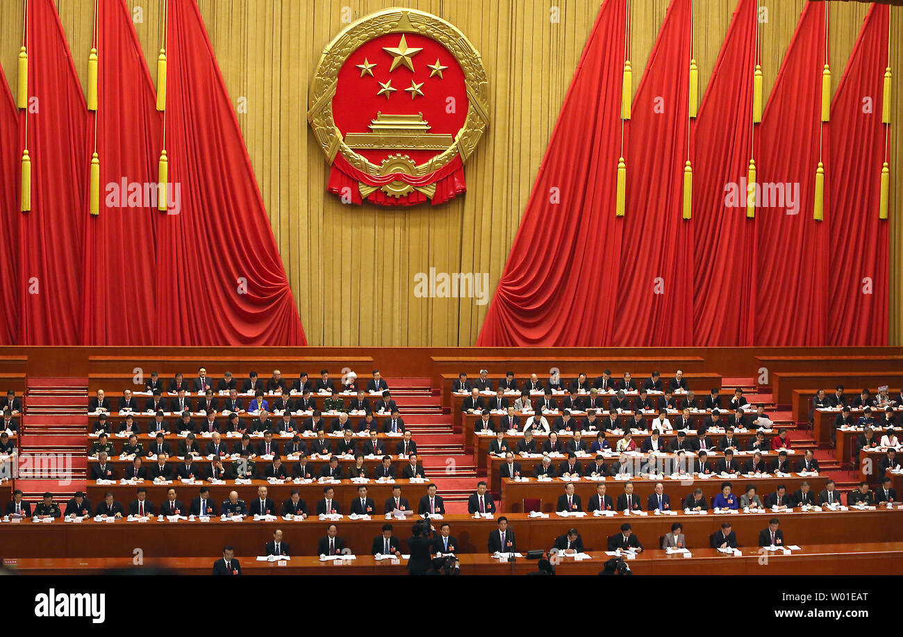 China's top government delegates attend the opening session of the ...
