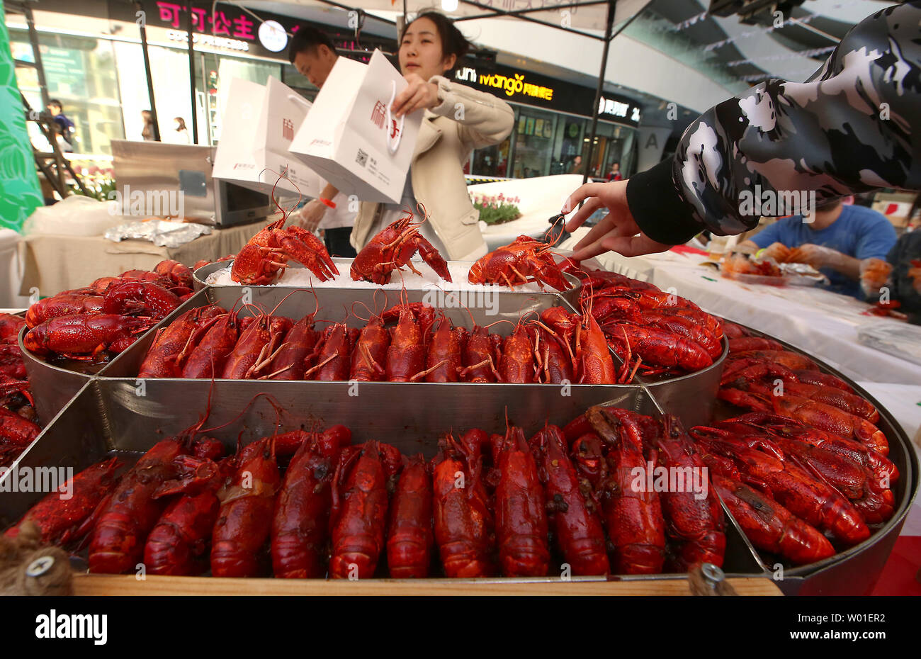 Chinese crayfish are sold at a food stall in Beijing on April 22, 2018 ...