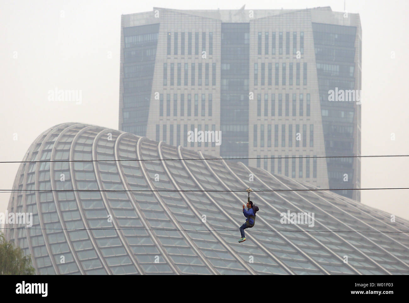 A Chinese man rides a zip-line at a park in central Beijing on May 21 ...