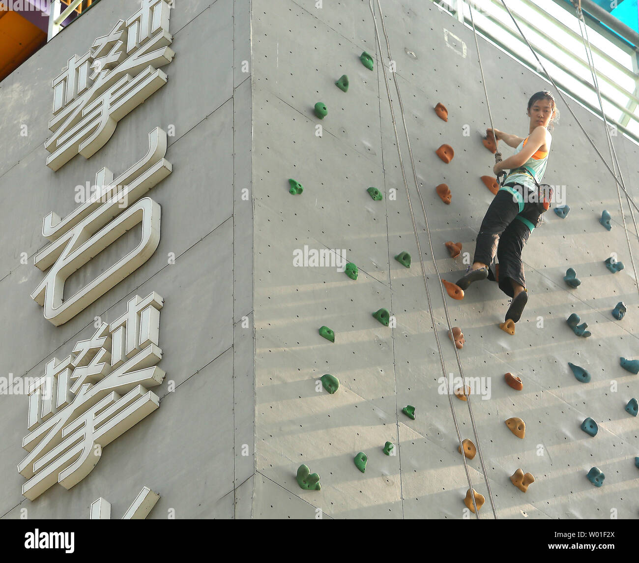 A Chinese woman reaches the top of a 40m outdoor climbing wall in ...