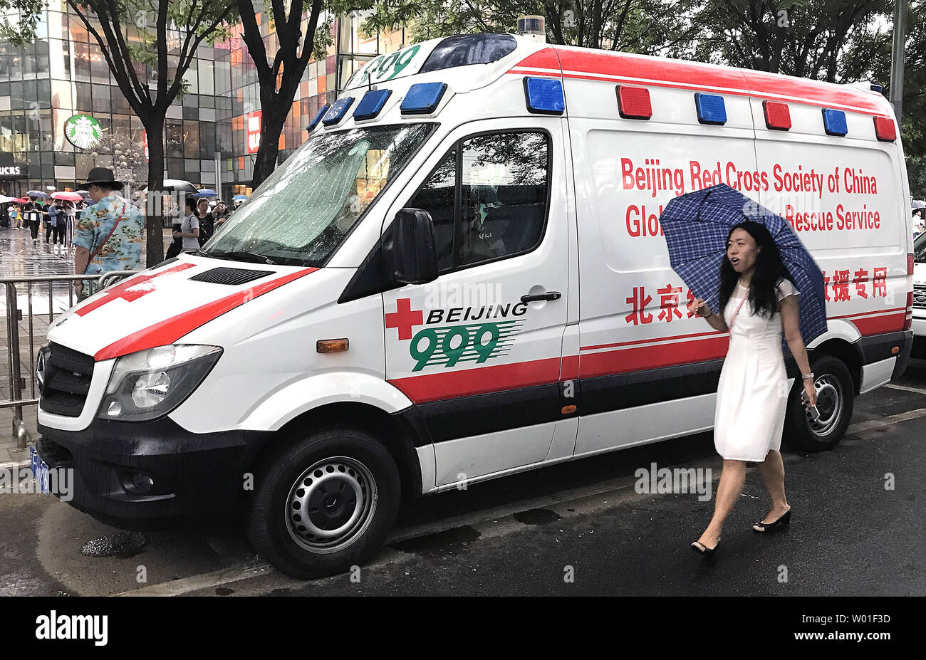 A Beijing Red Cross Rescue van is parked outside a major international ...