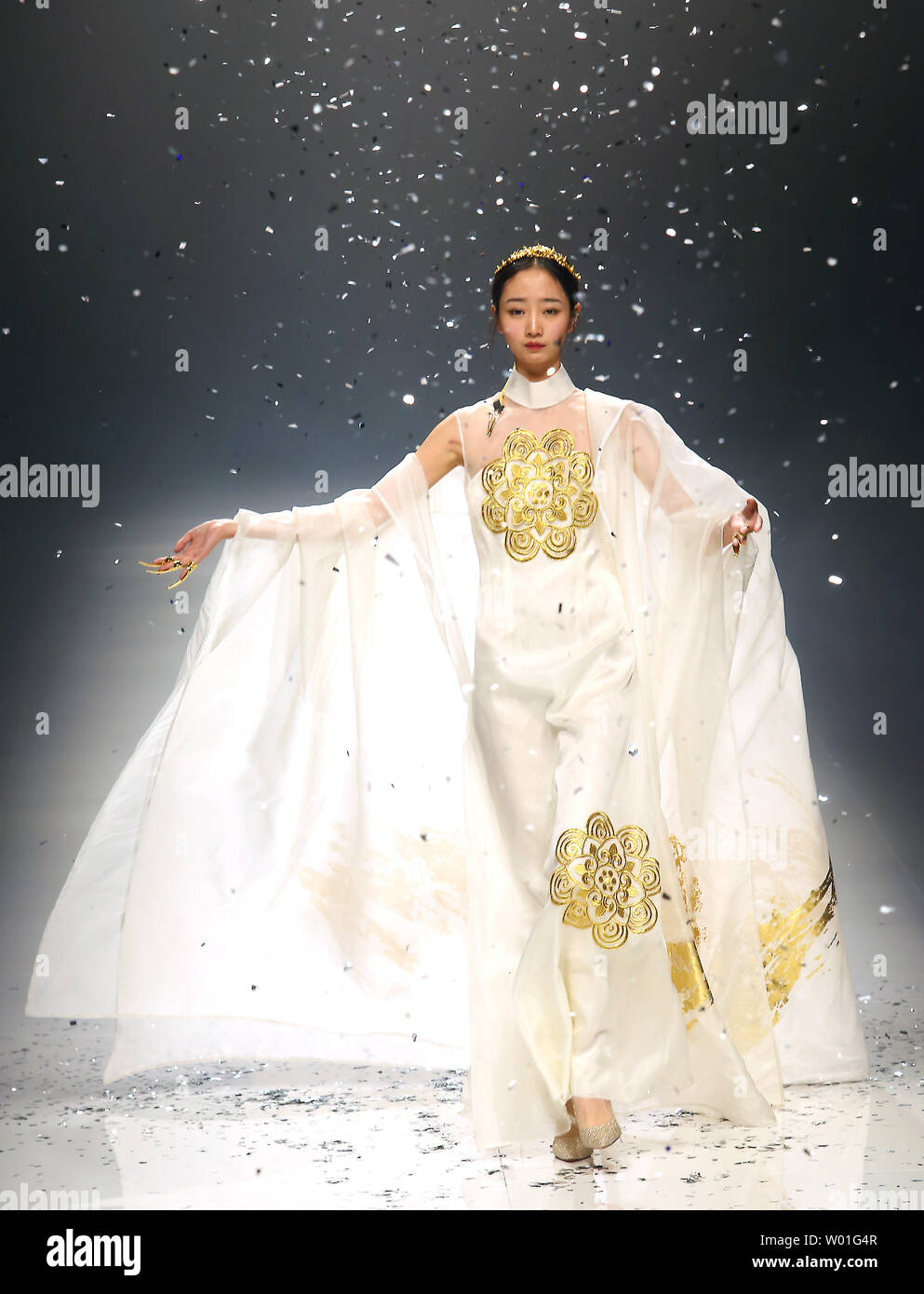Models wear the latest designs from Gary Wat during the annual Fashion ...