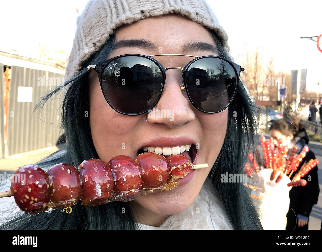 Chinese eat traditional sweets at a park during Chinese Lunar New Year ...