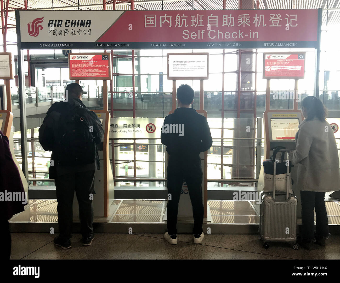 Passengers self check-in at Beijing's international airport on March 11 ...