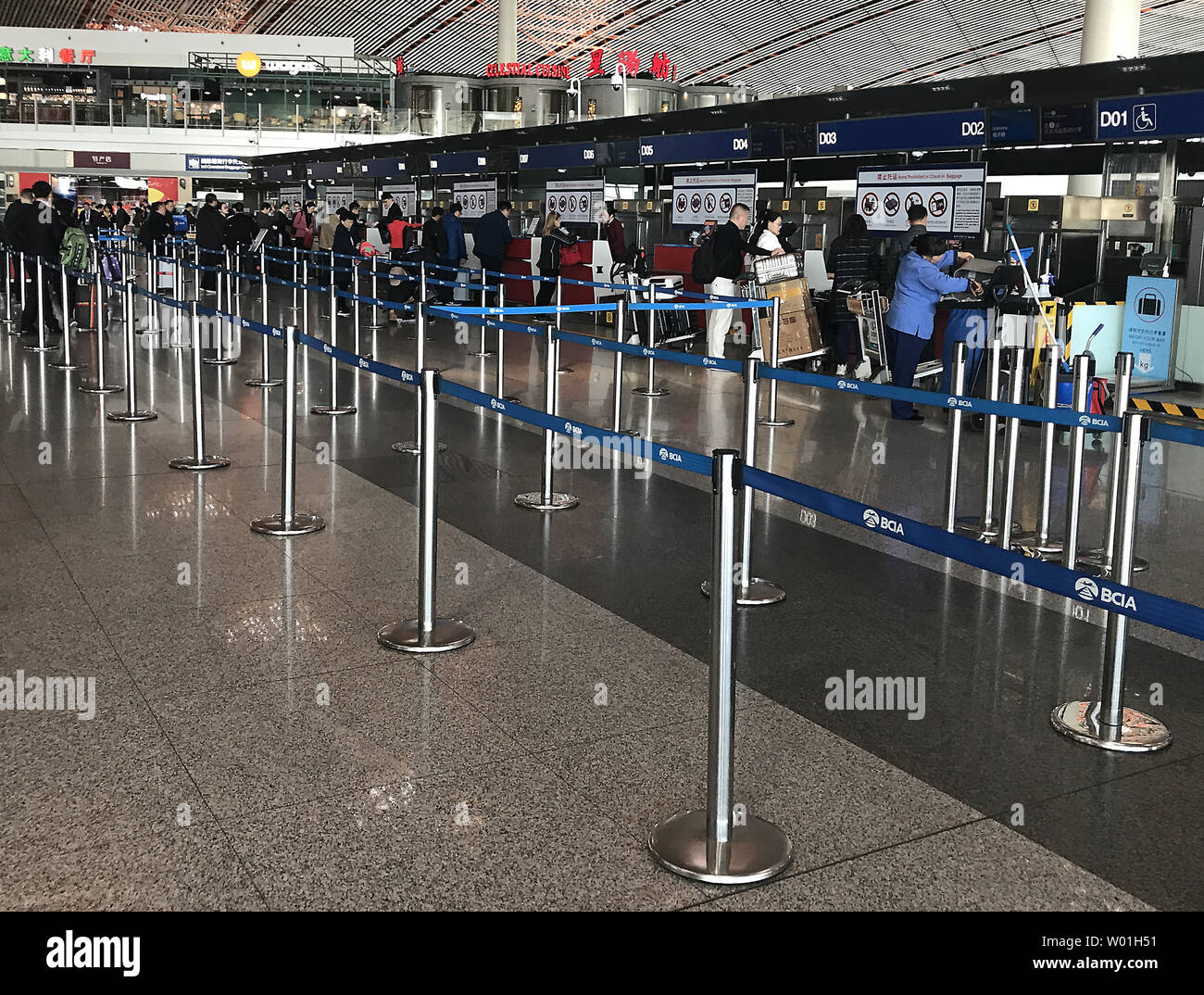 Passengers check-in at a ticket counter in Beijing's international ...