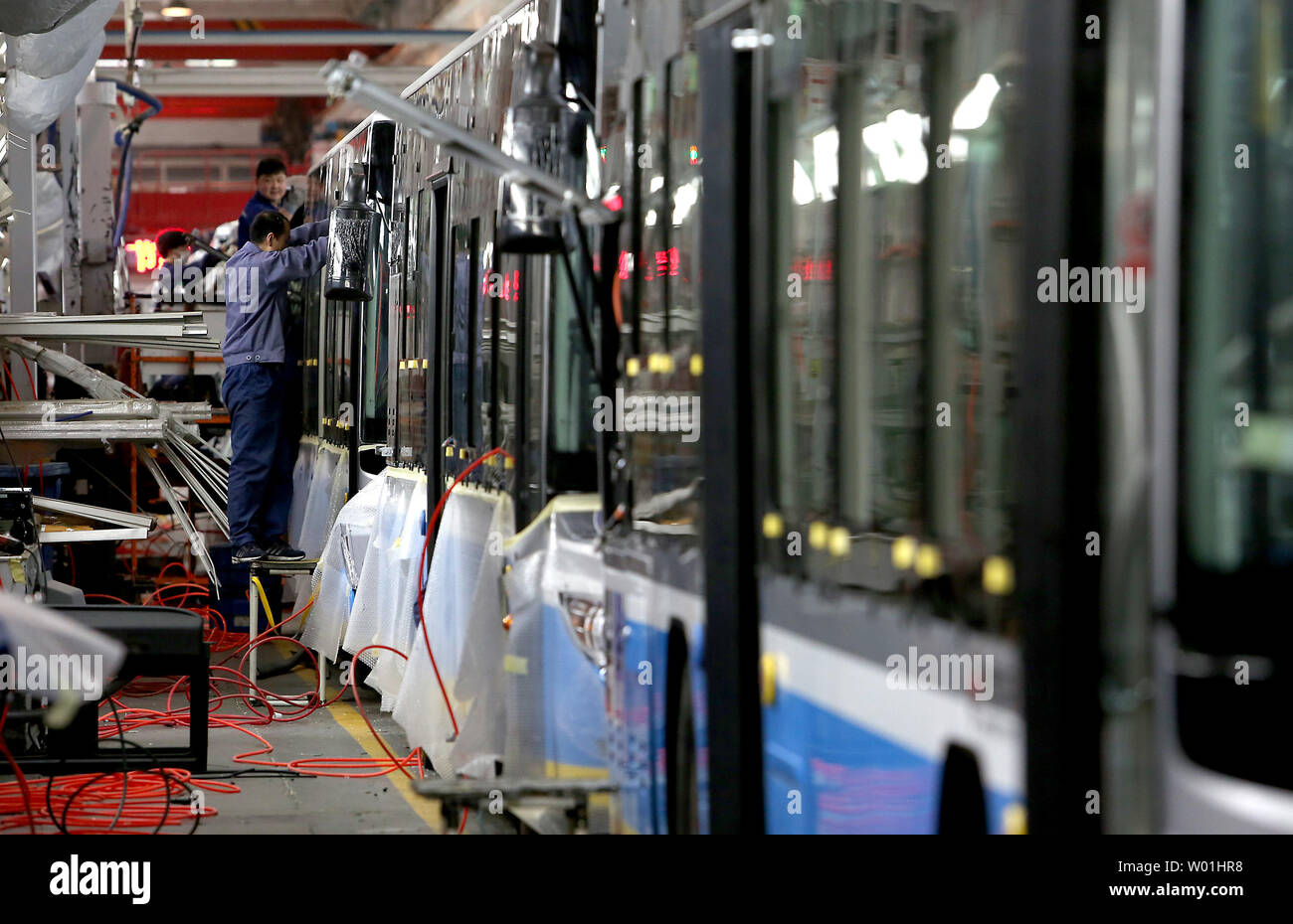 China's Foton AUV electric buses are built on an assembly line at their ...