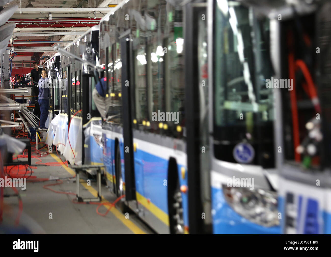 China's Foton AUV electric buses are built on an assembly line at their ...