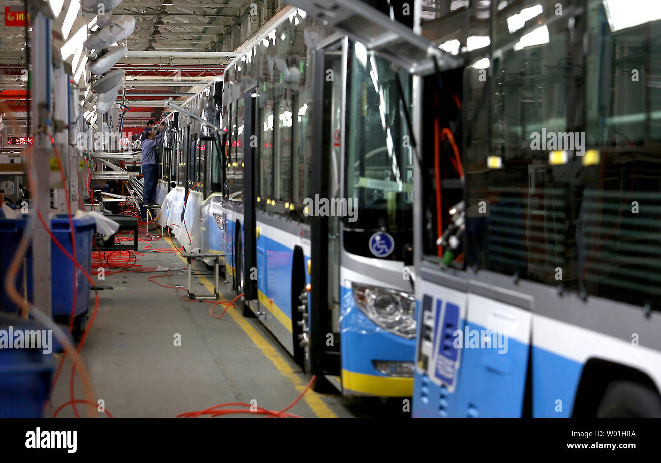 China's Foton AUV electric buses are built on an assembly line at their ...
