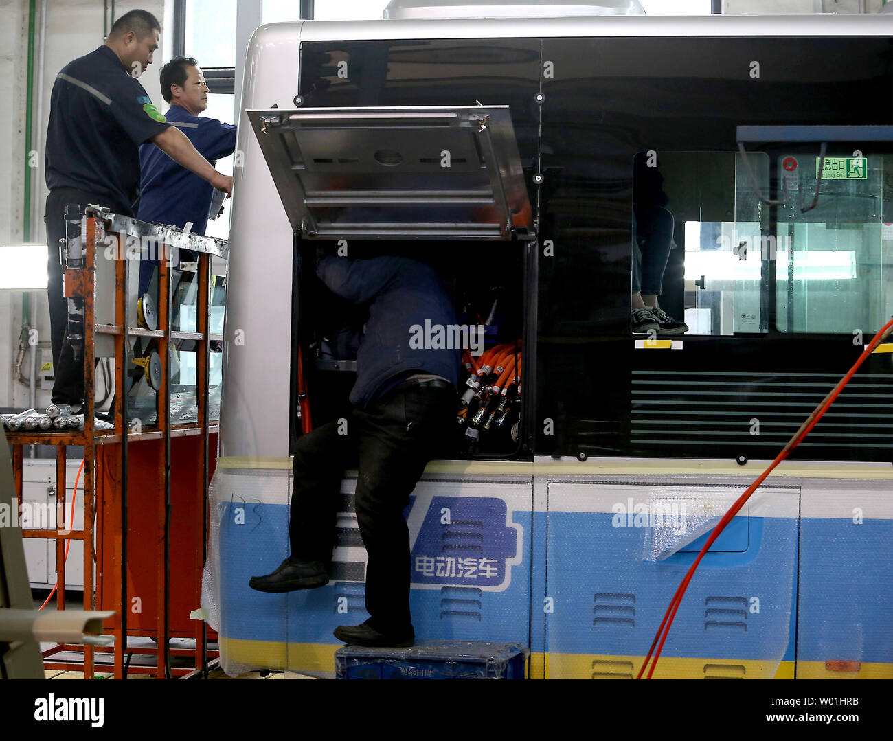 China's Foton AUV electric buses are built on an assembly line at their ...