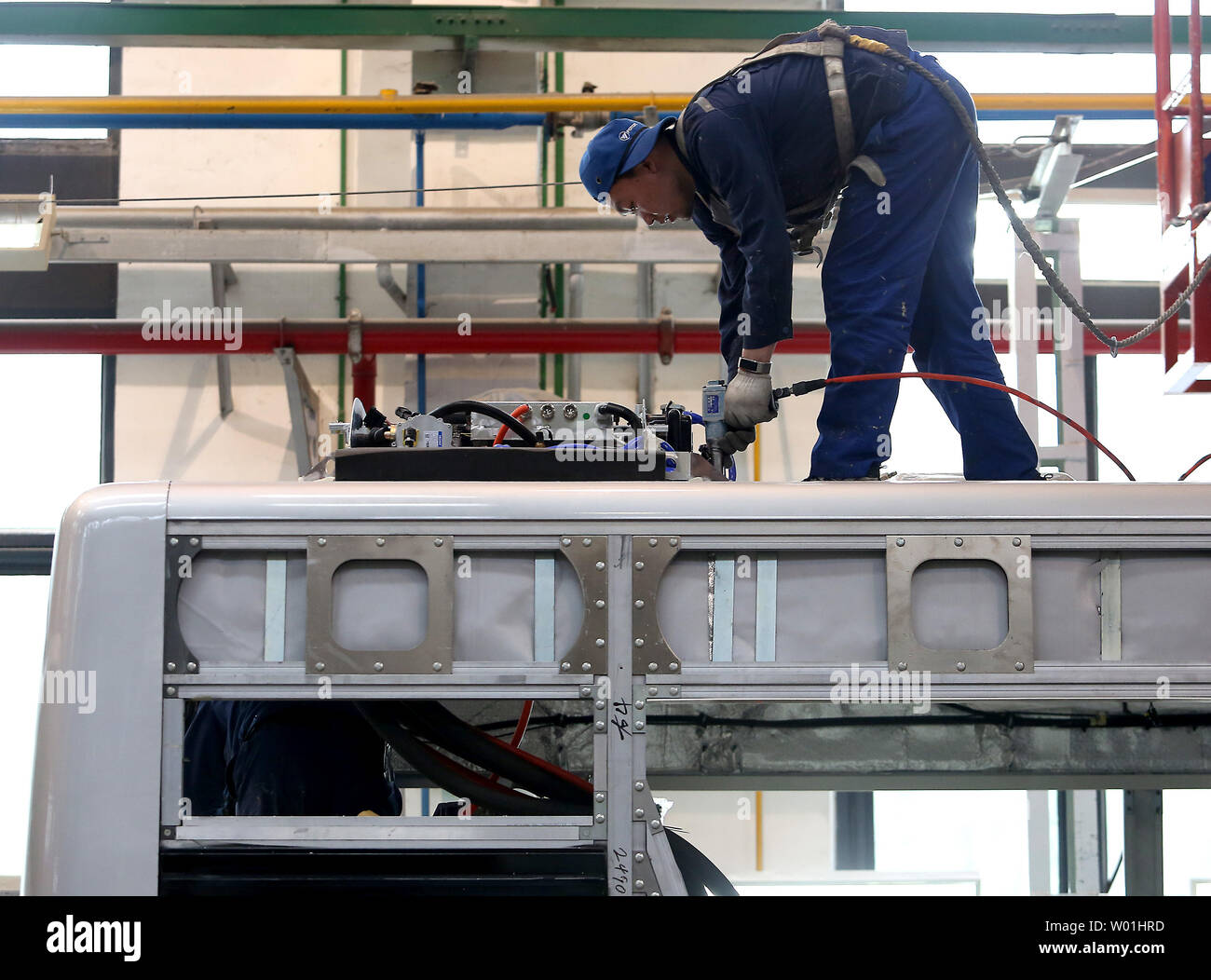 China's Foton AUV electric buses are built on an assembly line at their ...