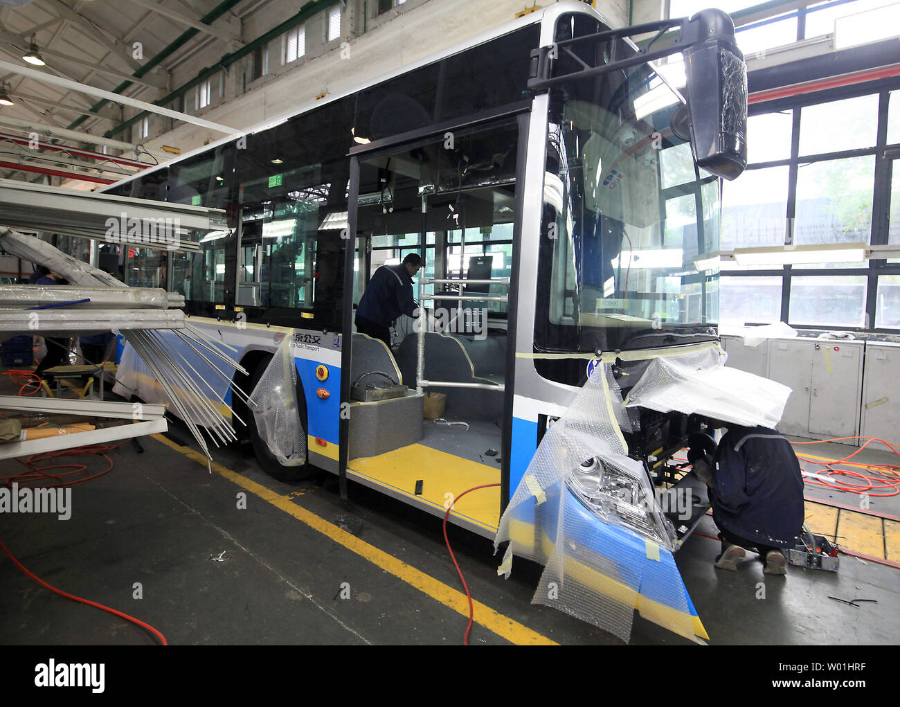 China's Foton AUV electric buses are built on an assembly line at their ...