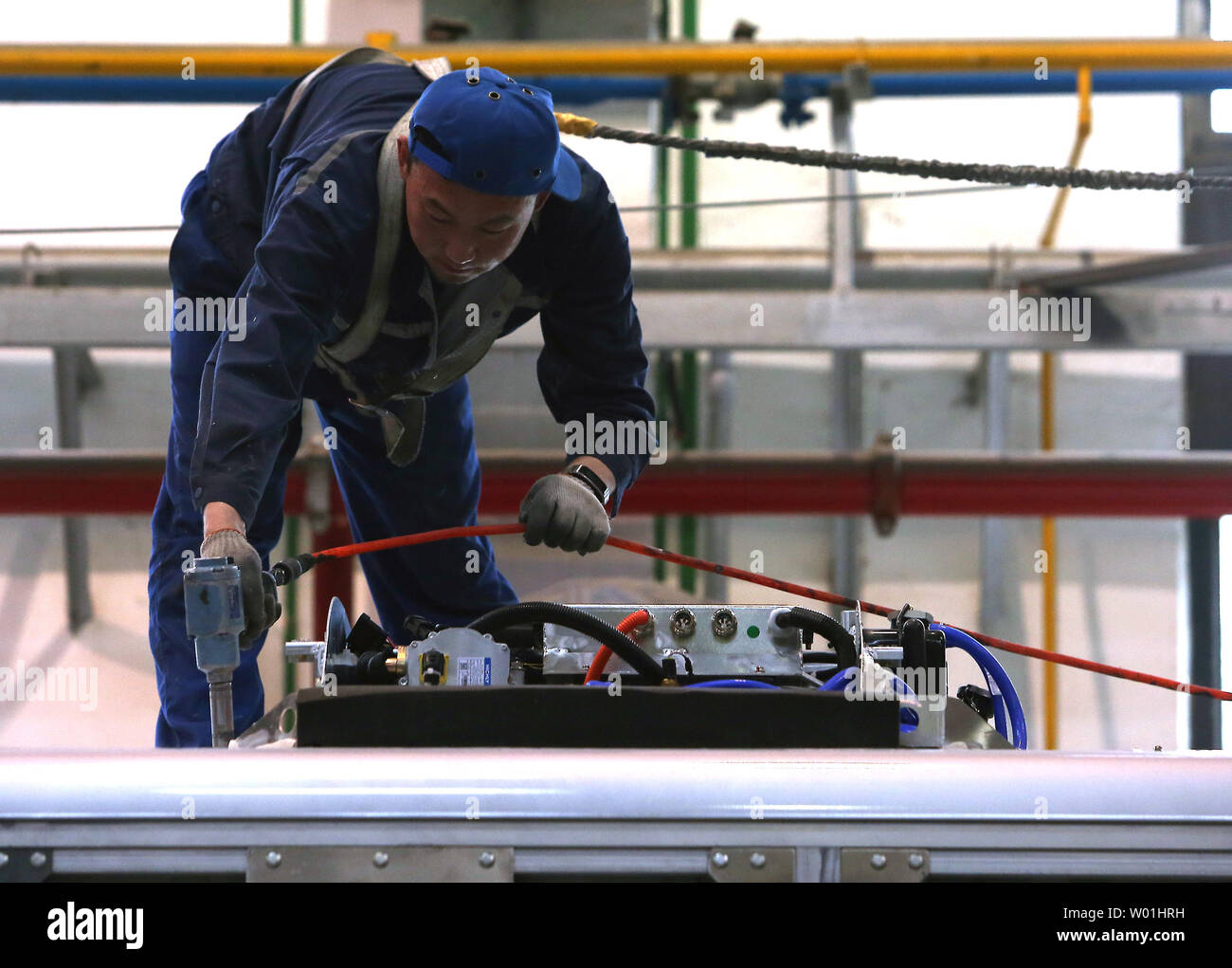 China's Foton AUV electric buses are built on an assembly line at their ...
