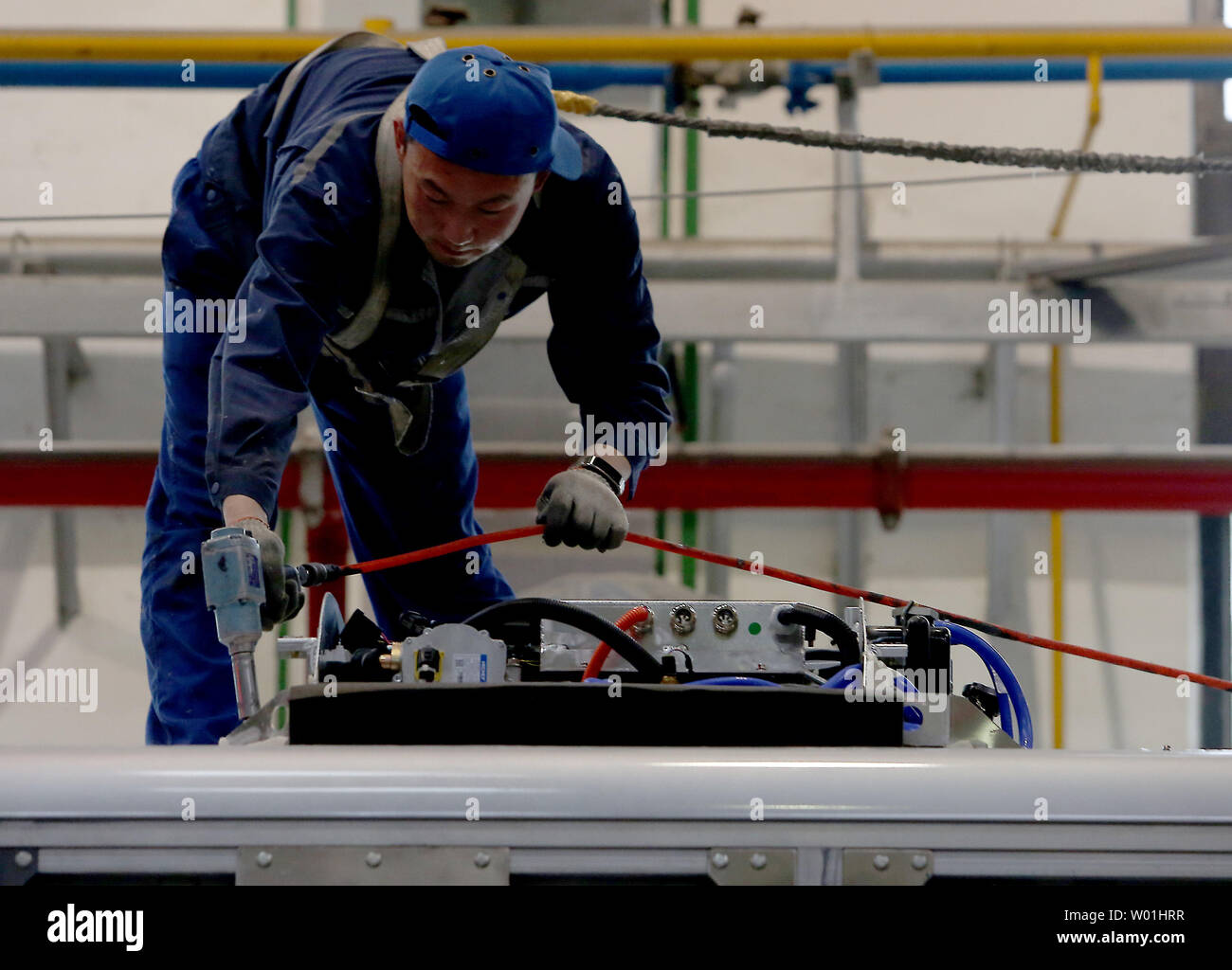 China's Foton AUV electric buses are built on an assembly line at their ...