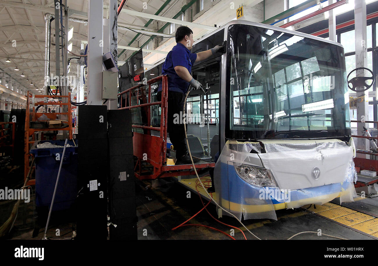 China's Foton AUV electric buses are built on an assembly line at their ...
