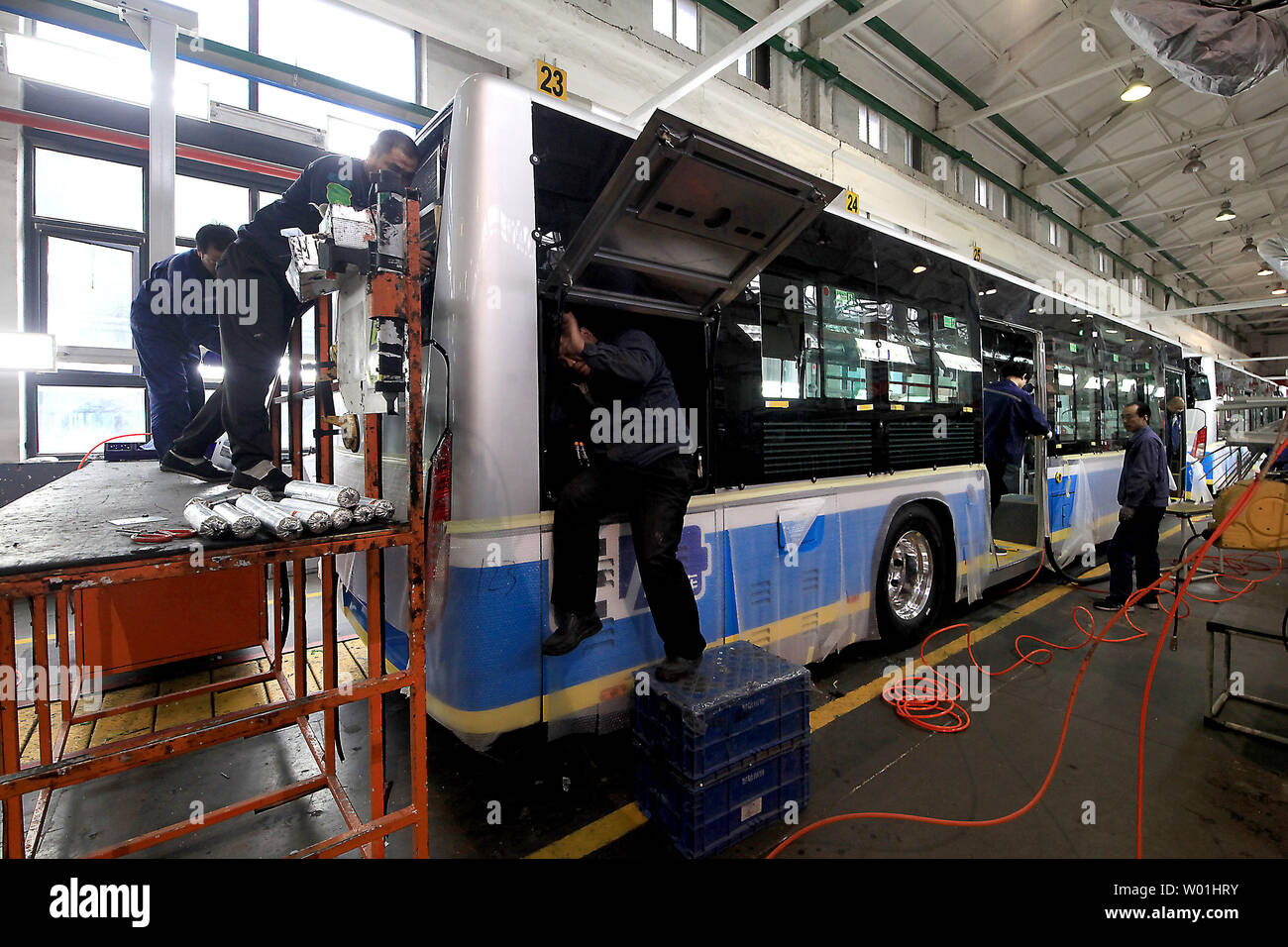 China's Foton AUV electric buses are built on an assembly line at their ...
