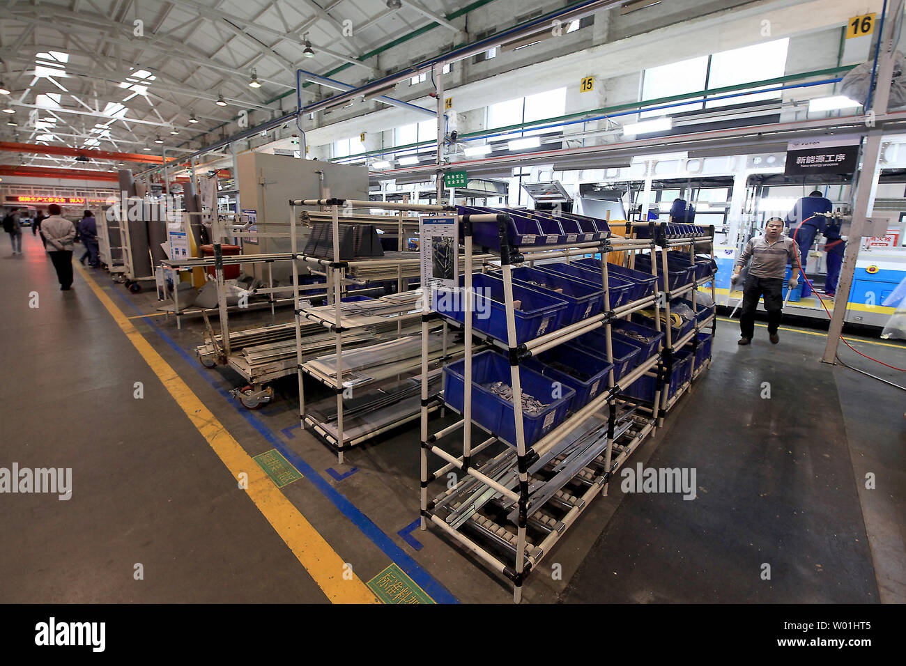 China's Foton AUV electric buses are built on an assembly line at their ...