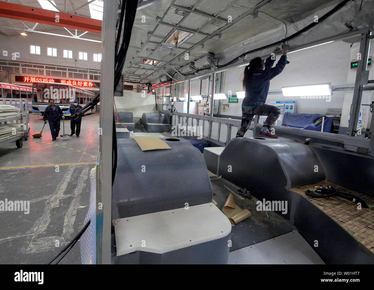 China's Foton AUV electric buses are built on an assembly line at their ...