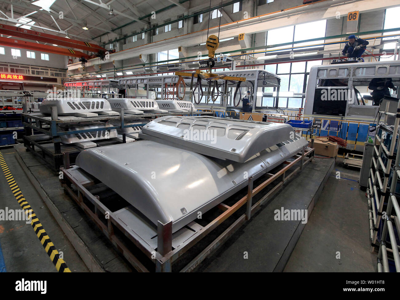 China's Foton AUV electric buses are built on an assembly line at their ...