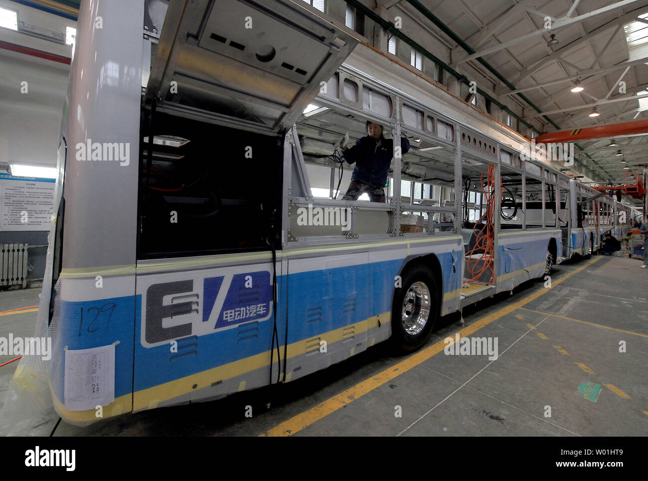 China's Foton AUV electric buses are built on an assembly line at their ...