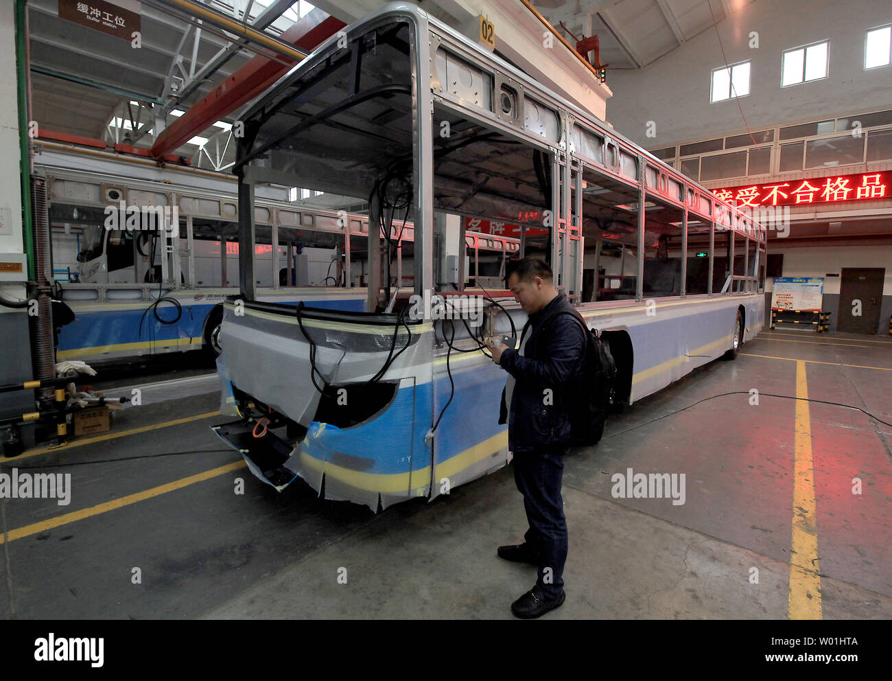 China's Foton AUV electric buses are built on an assembly line at their ...