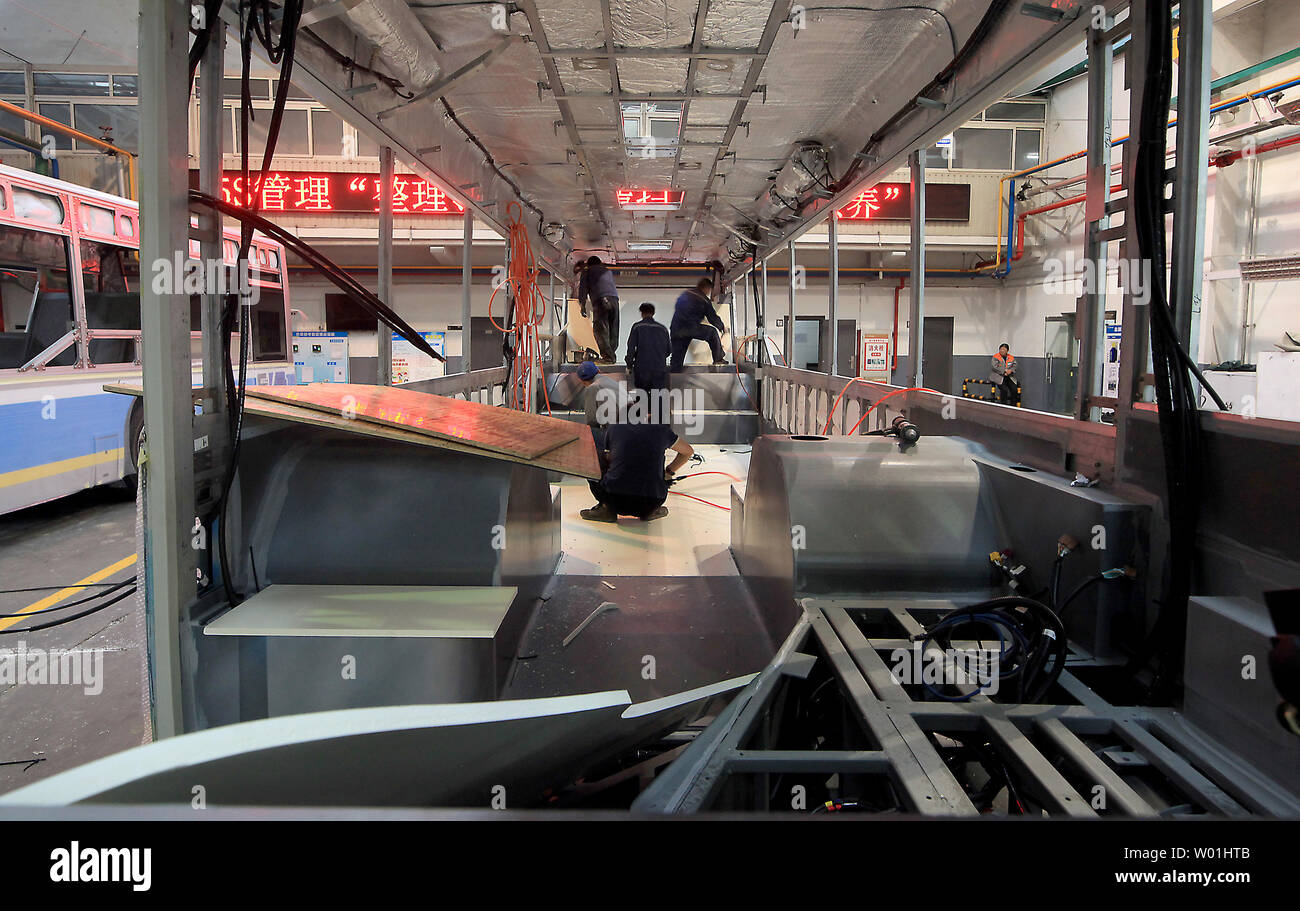 China's Foton AUV electric buses are built on an assembly line at their ...