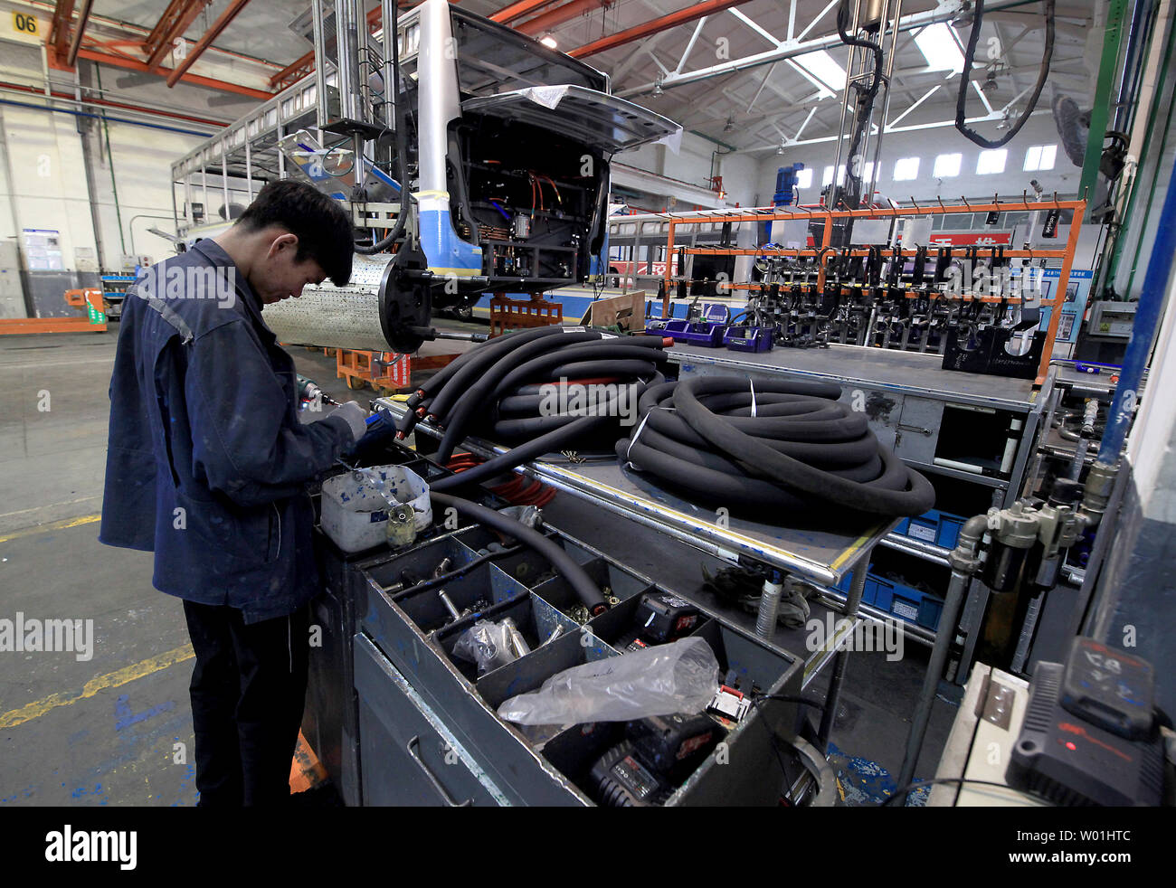 China's Foton AUV electric buses are built on an assembly line at their ...