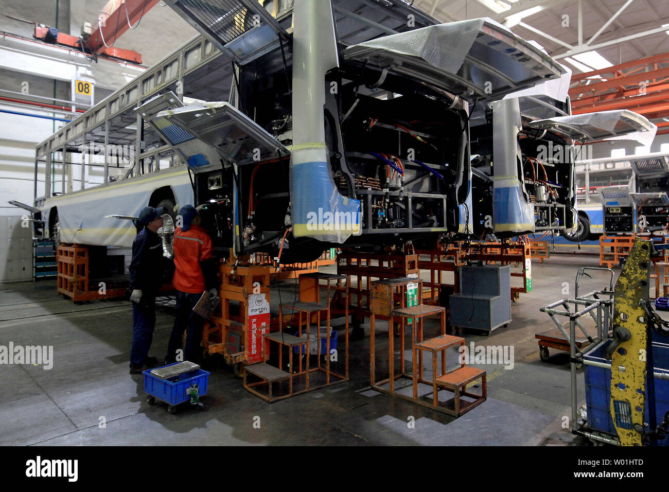 China's Foton AUV electric buses are built on an assembly line at their ...