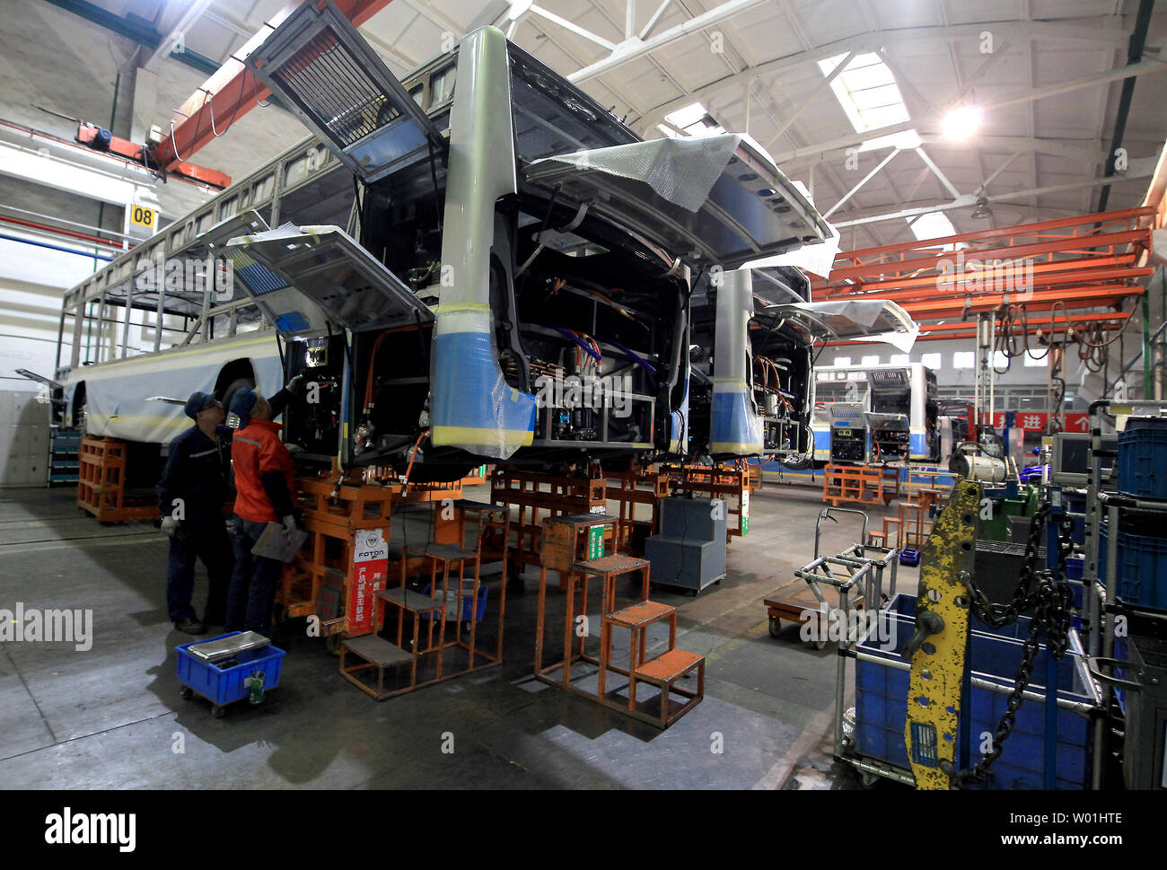 China's Foton AUV electric buses are built on an assembly line at their ...