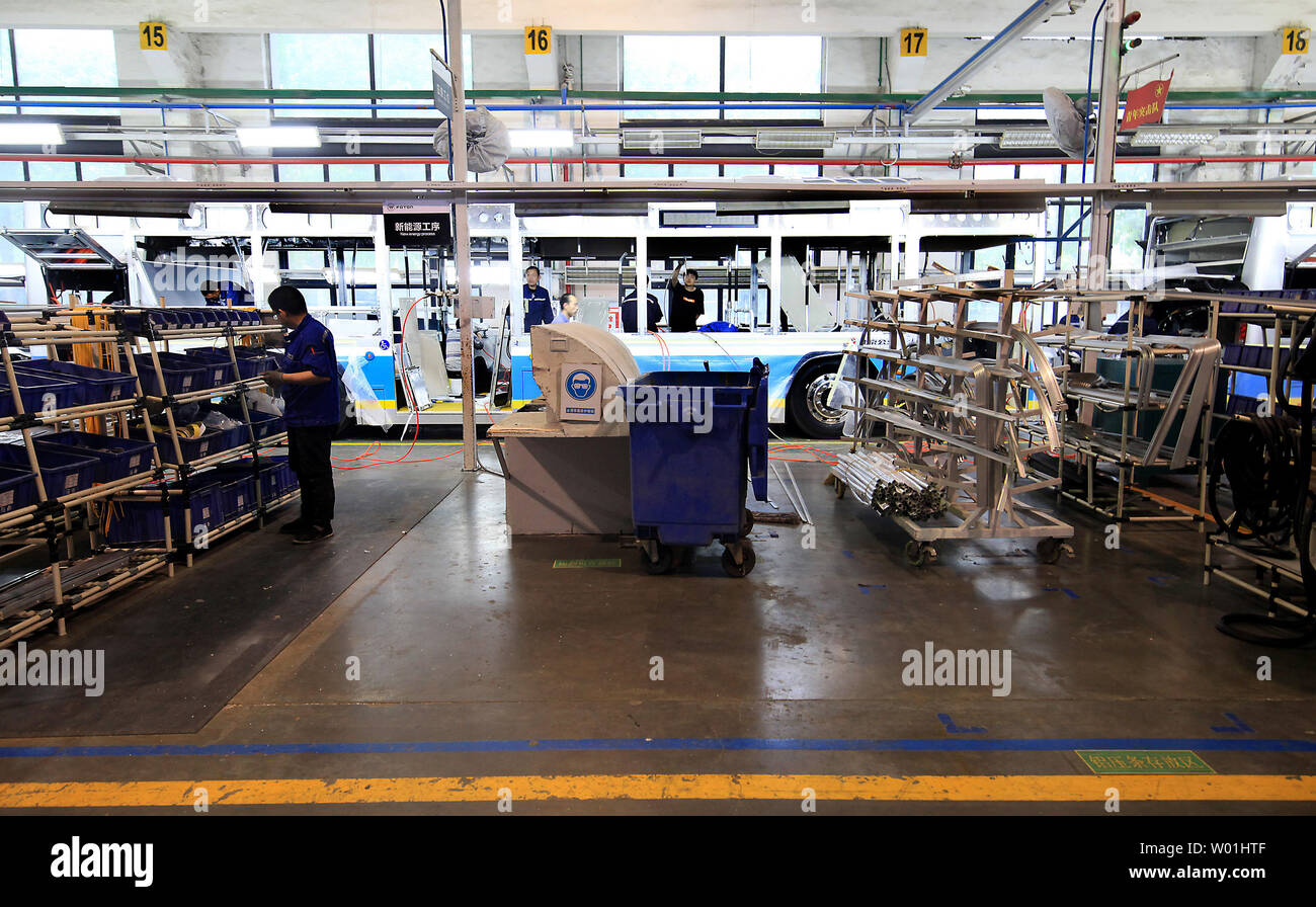 China's Foton AUV electric buses are built on an assembly line at their ...