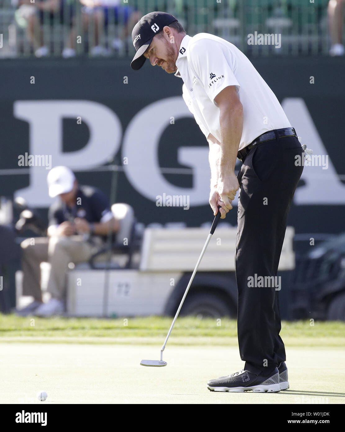 Jimmy Walker putts on the 14th green in the first round at the PGA ...