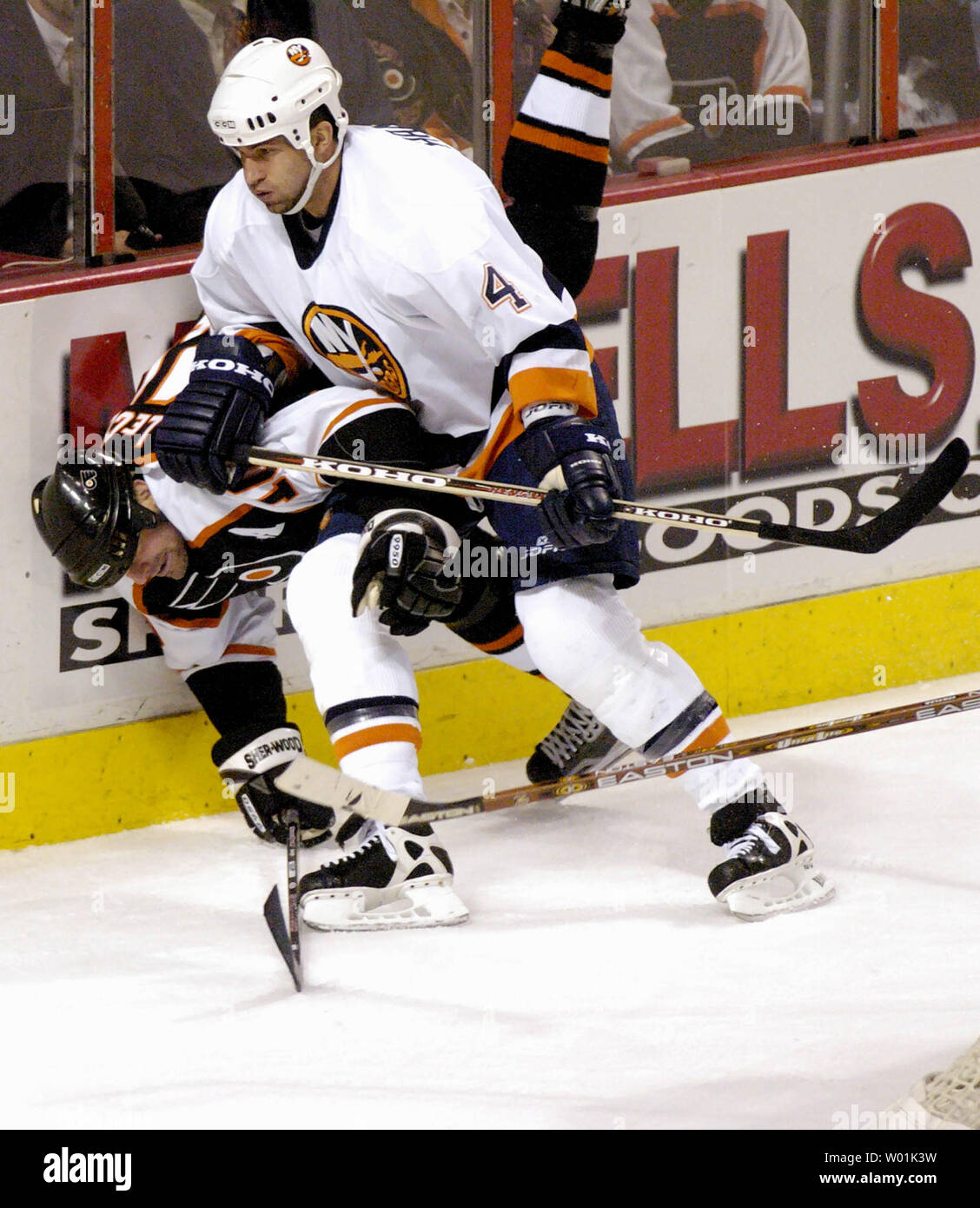 The Flyers' John LeClair (10) gets pinned to the corner by the Islander ...