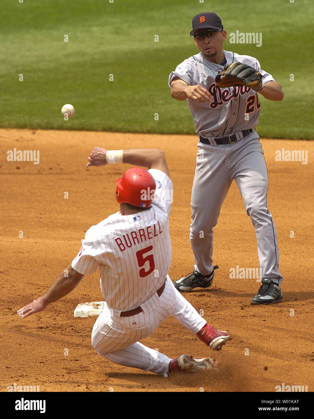 The Phillies' David Bell hits into a double play when the Tigers' Omar ...